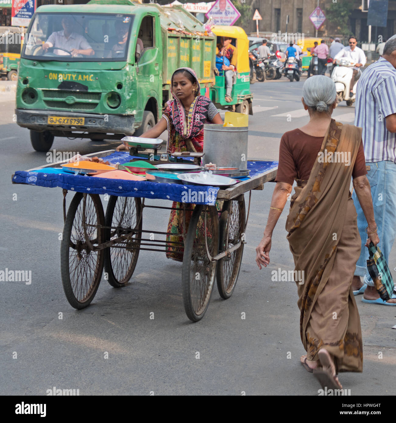 An unidentified trader wheeling a cart laden with dyes through early ...