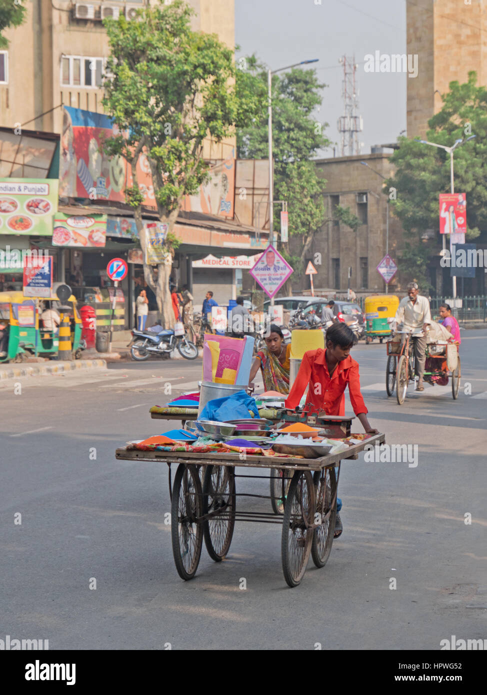 An unidentified trader wheeling a cart laden with dyes through the ...
