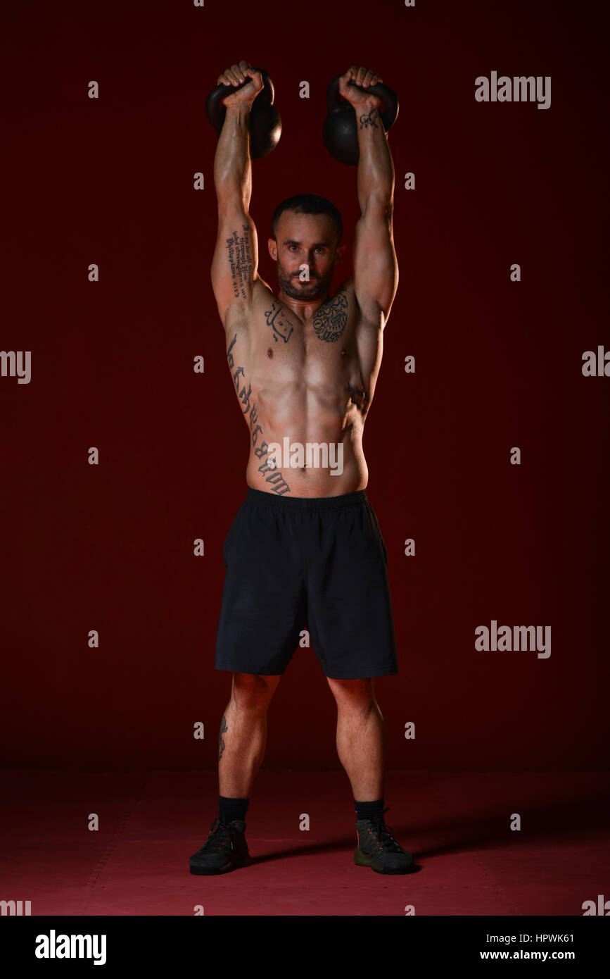 Young Man Working Out With Kettle Bell In A Gym - Bodybuilder Doing ...