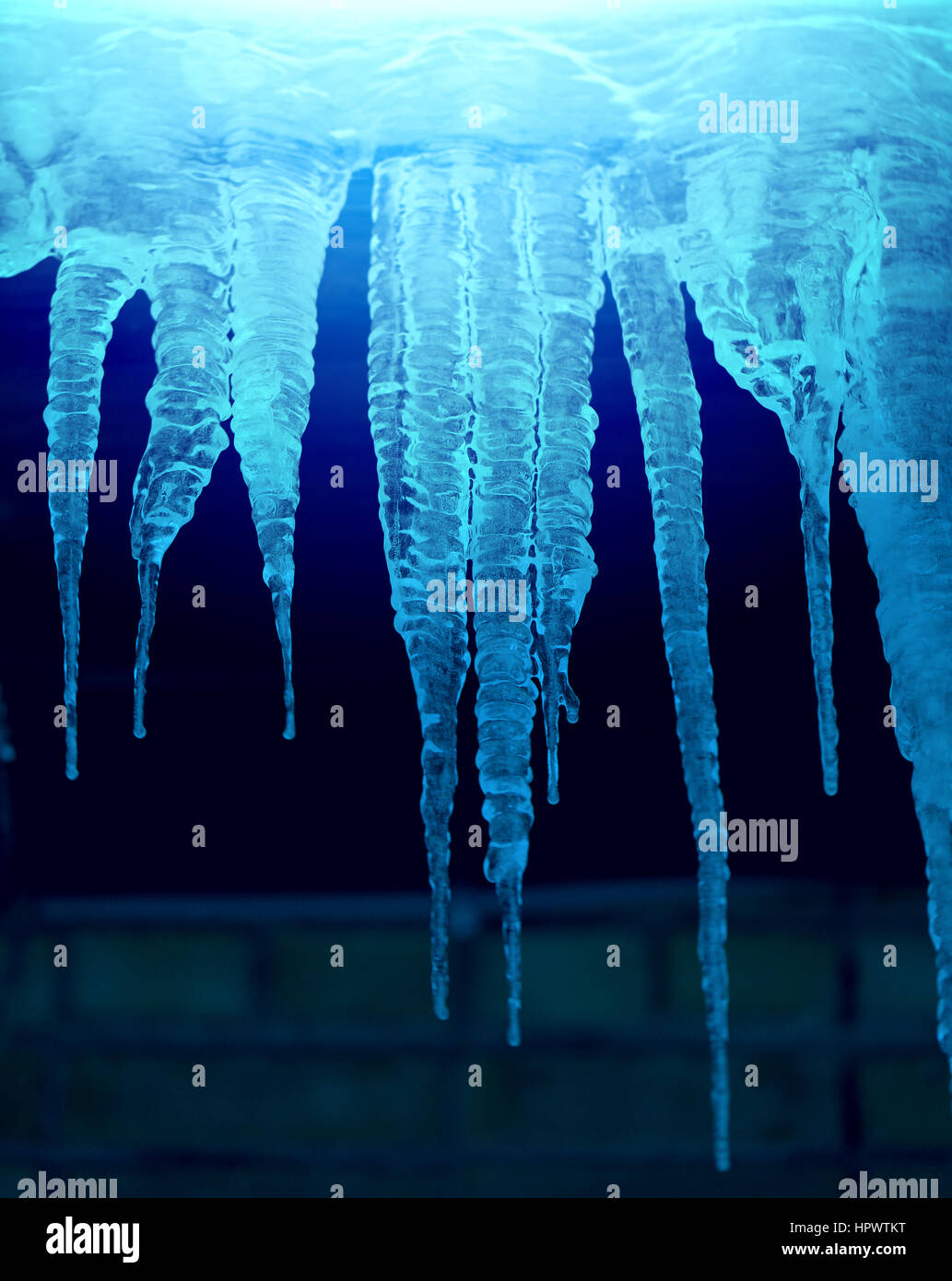 Beautiful icicles photographed closeup on a blue background Stock Photo ...