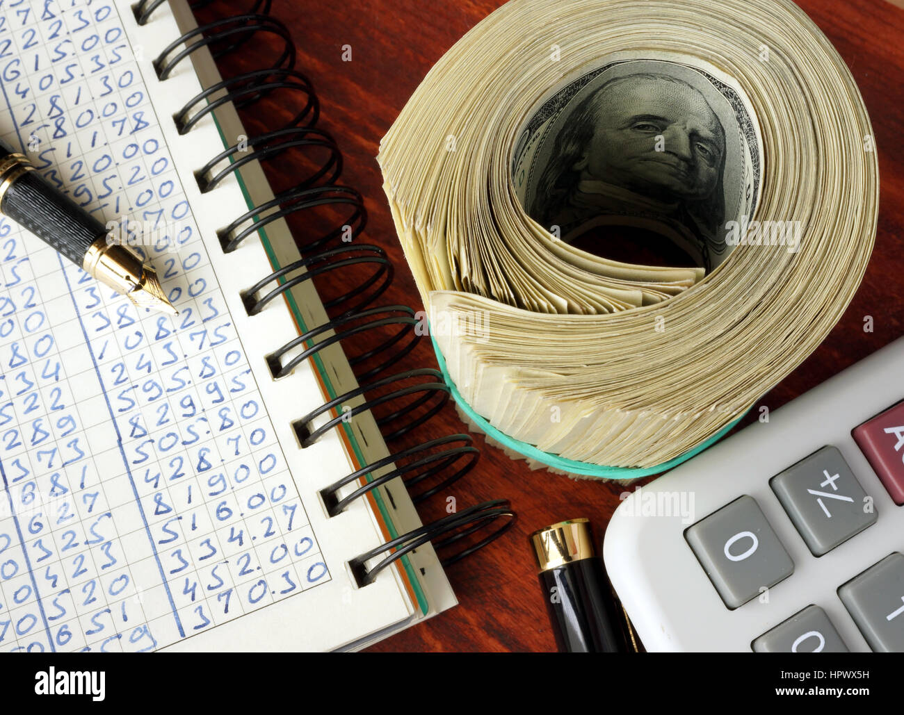 Ledger, pack of dollars and calculator. Accounting concept Stock Photo ...