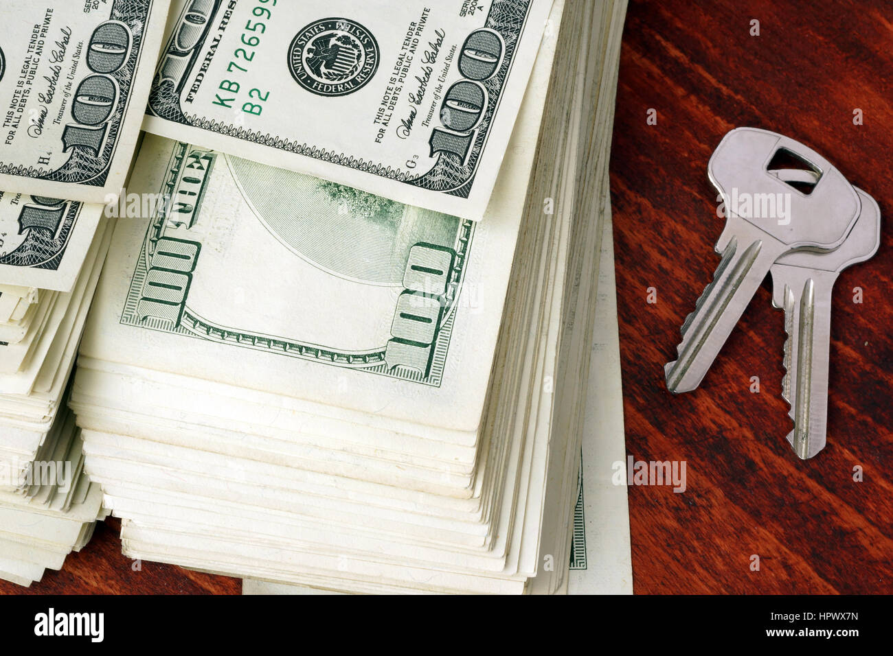 Buying a house concept. Pack of dollars and keys Stock Photo - Alamy