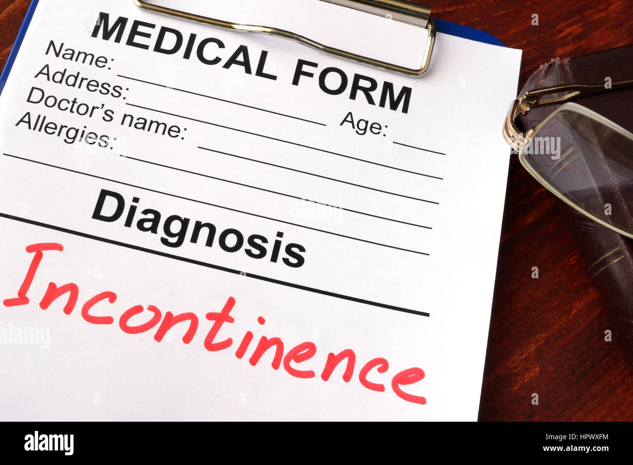 Medical form with diagnosis Incontinence on a table Stock Photo - Alamy