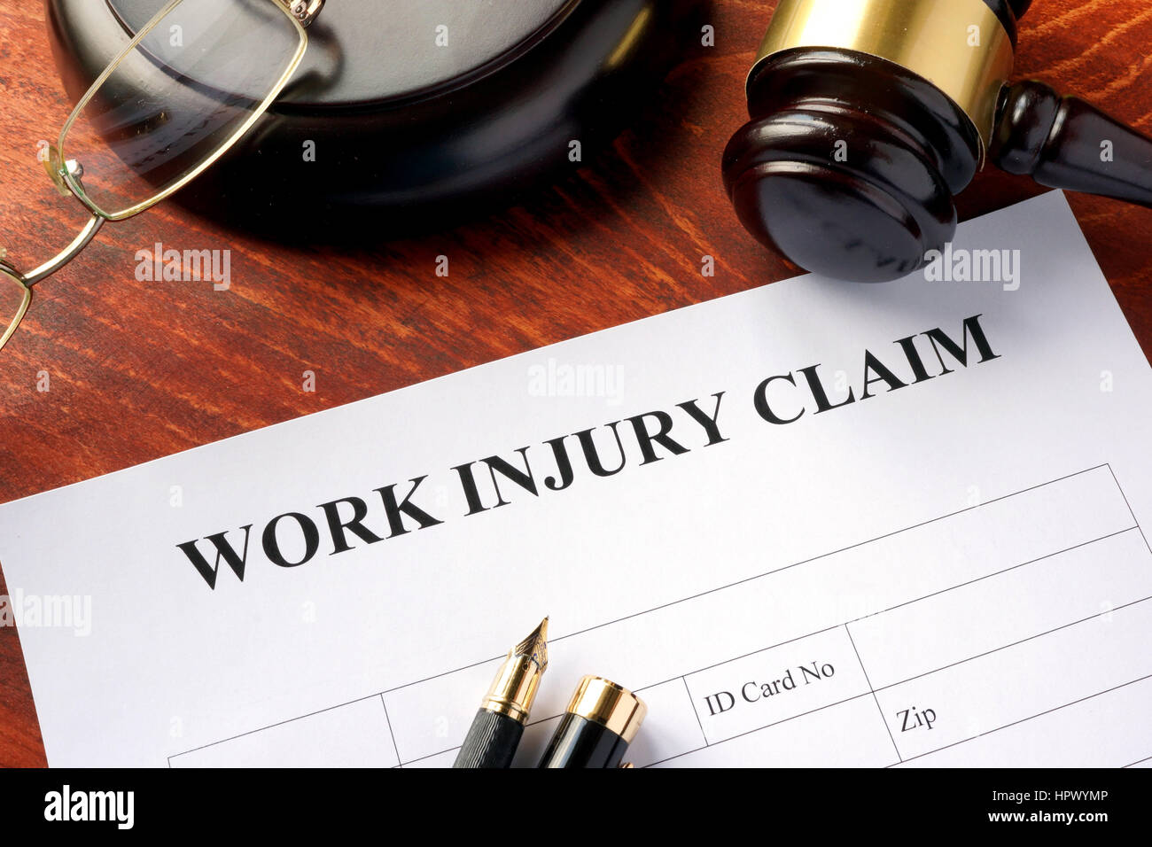 Work injury claim form on a table Stock Photo - Alamy