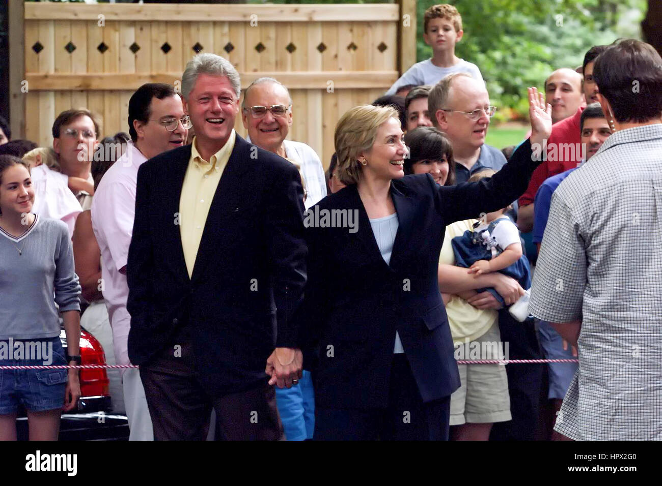 President Bill Clinton and his wife, Hillary Clinton wave to residents ...