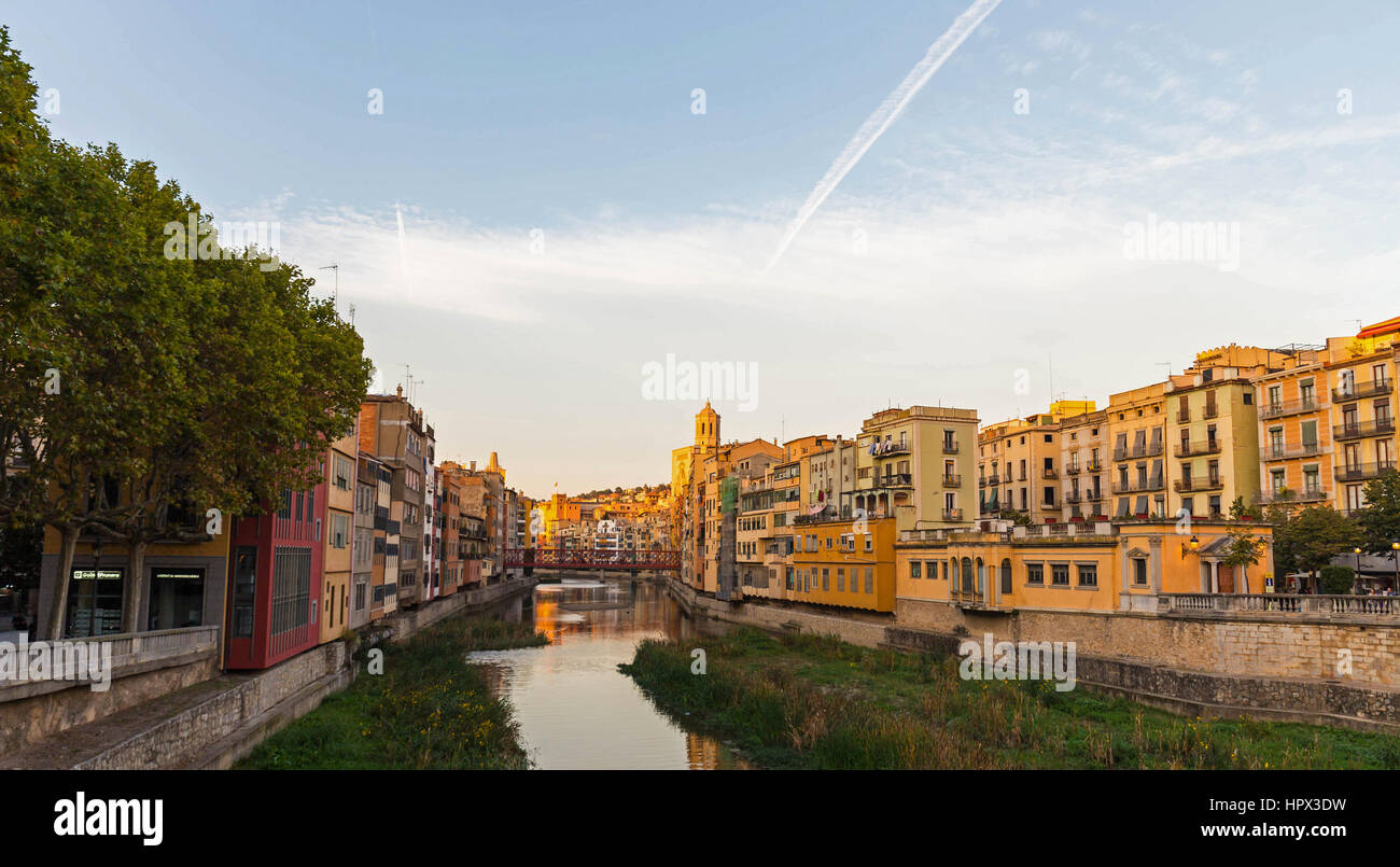 Onyar river crossing the downtown of Girona with bell tower of Basilica ...