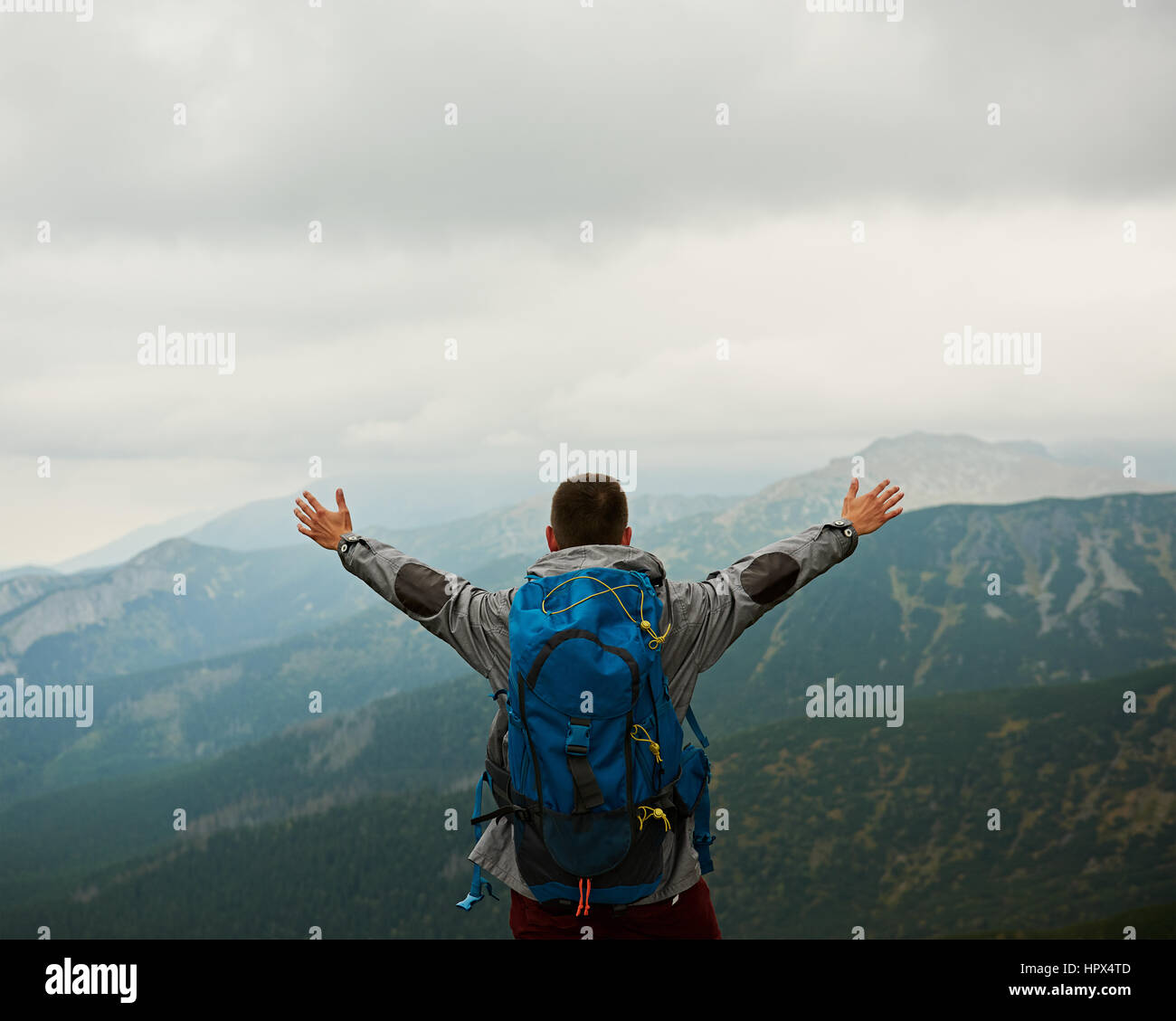 Man arms raised standing peak hi-res stock photography and images - Alamy