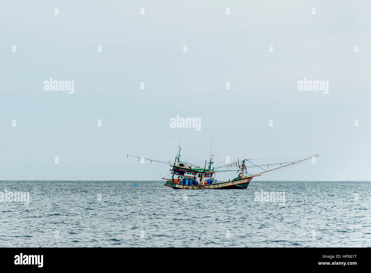 Fishing boat big fishermen with fish huge net on the blue ocean ...