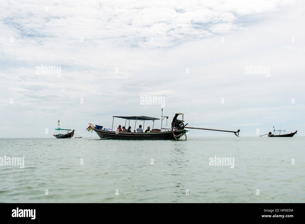 Thai traditional longtail boat with big diesel engine in action smoke ...