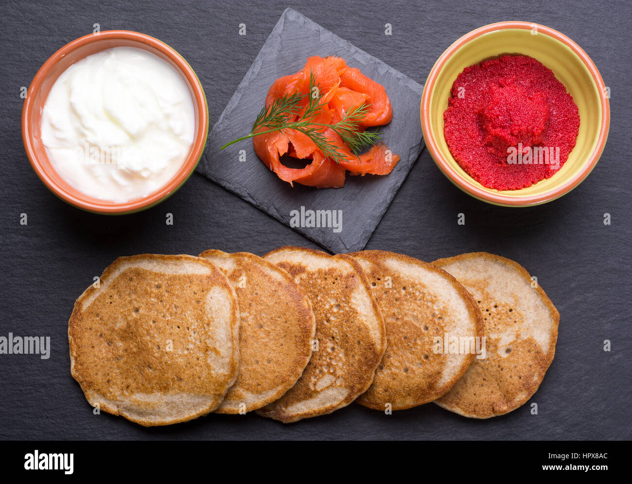 Traditional russian blini with sour cream and red caviar Stock Photo ...