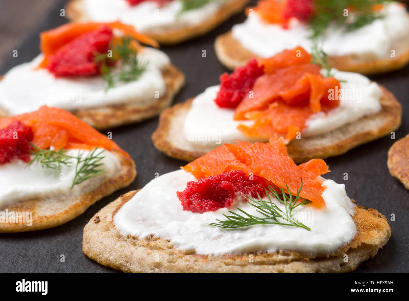Traditional russian blini with sour cream and red caviar. Selective ...