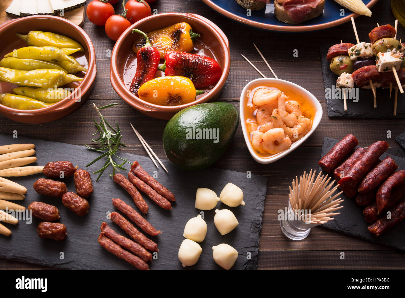 Mixed spanish tapas appetizers on dark brown wooden table. Top view ...