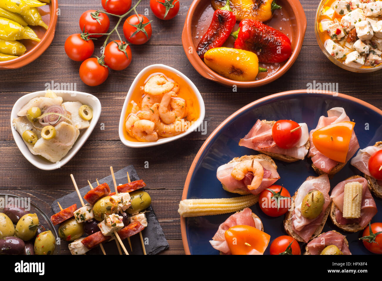 Spanish tapas starters on old wooden table. Top view Stock Photo - Alamy