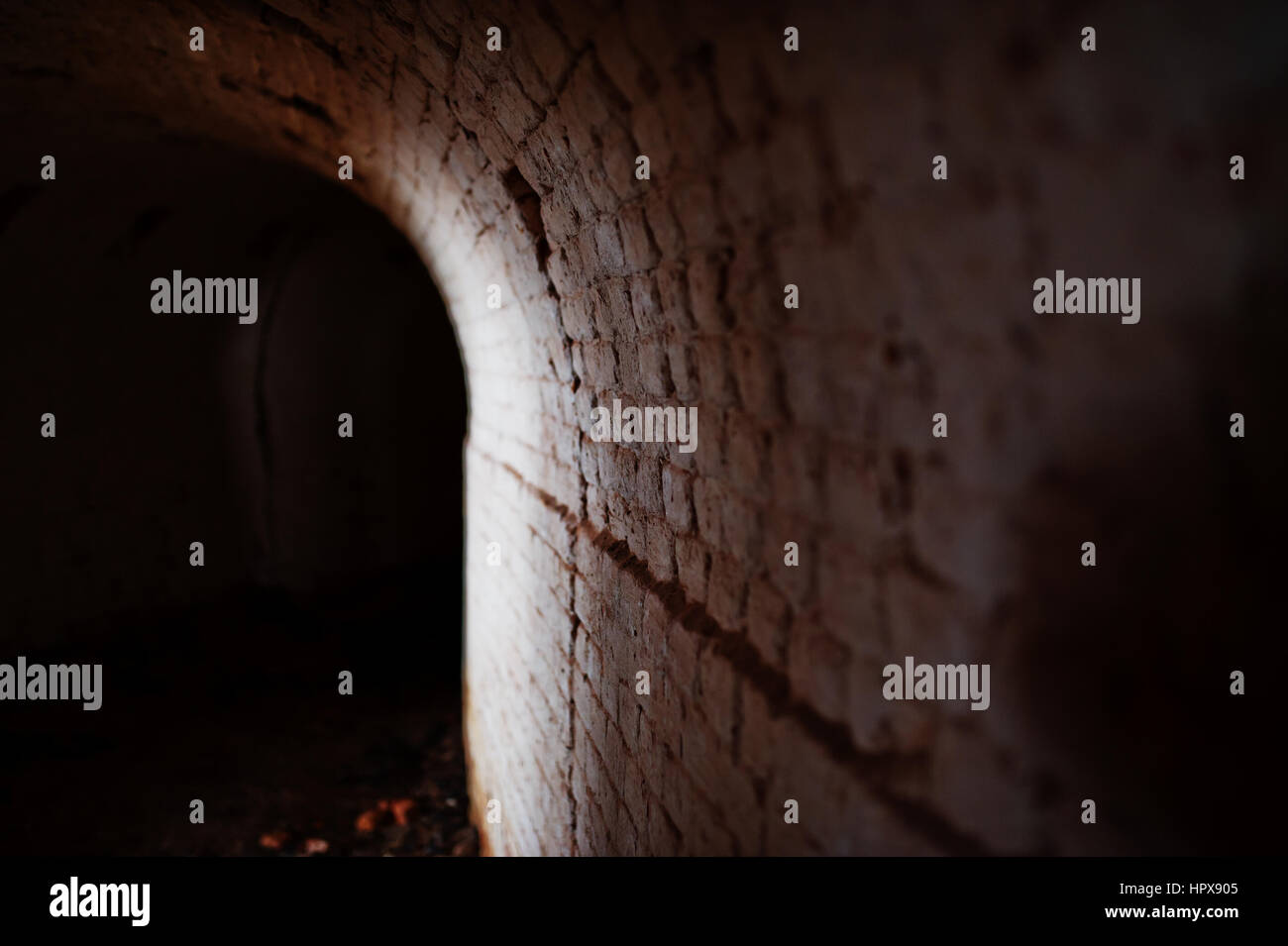 Scary brick arch tunnel on dark and some light Stock Photo - Alamy