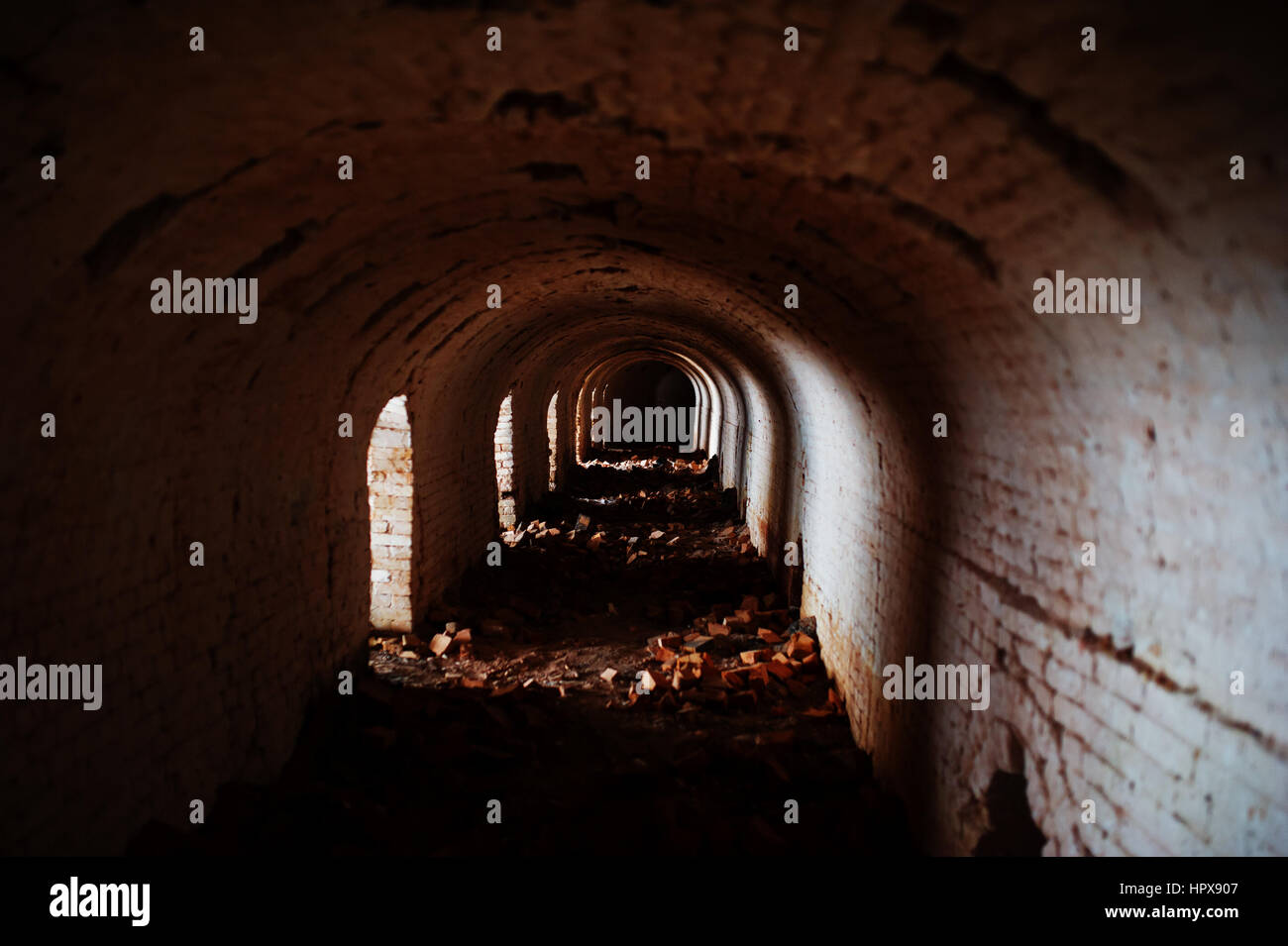 Scary brick arch tunnel on dark and some light Stock Photo - Alamy