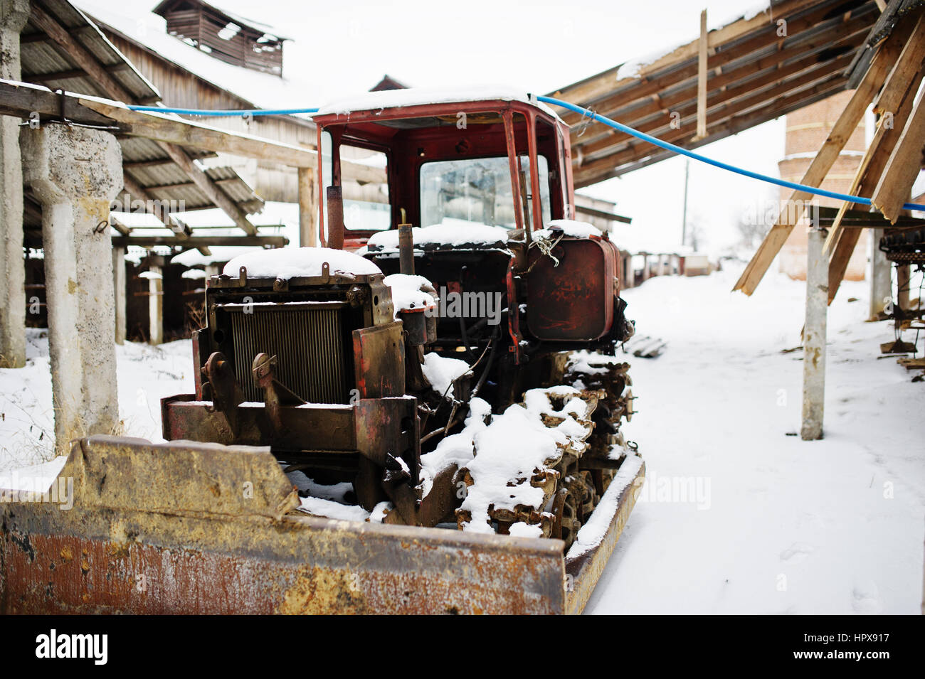 Rusty old soviet tractor covered by snow Stock Photo - Alamy