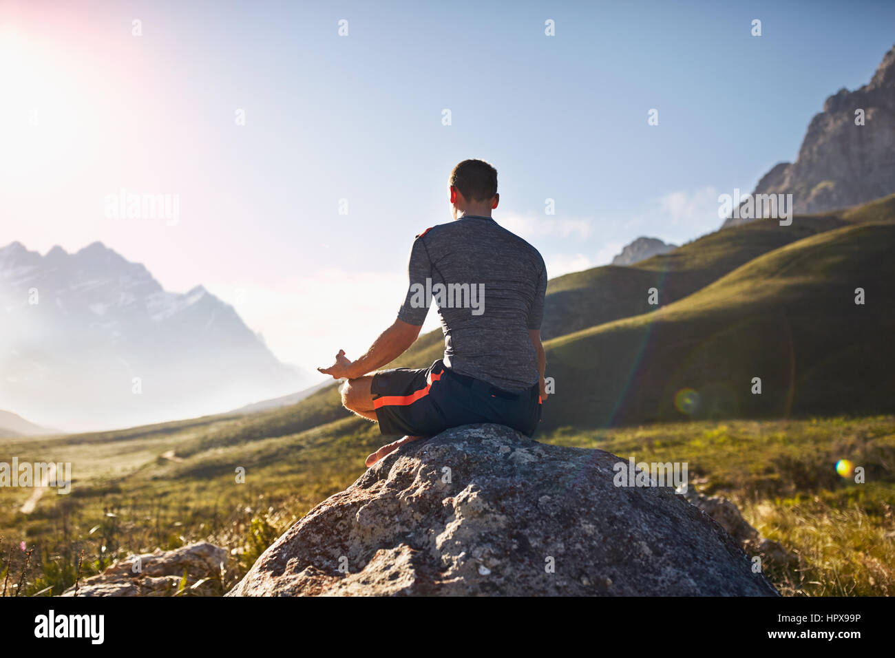 Rear view man meditating sitting hi-res stock photography and images ...