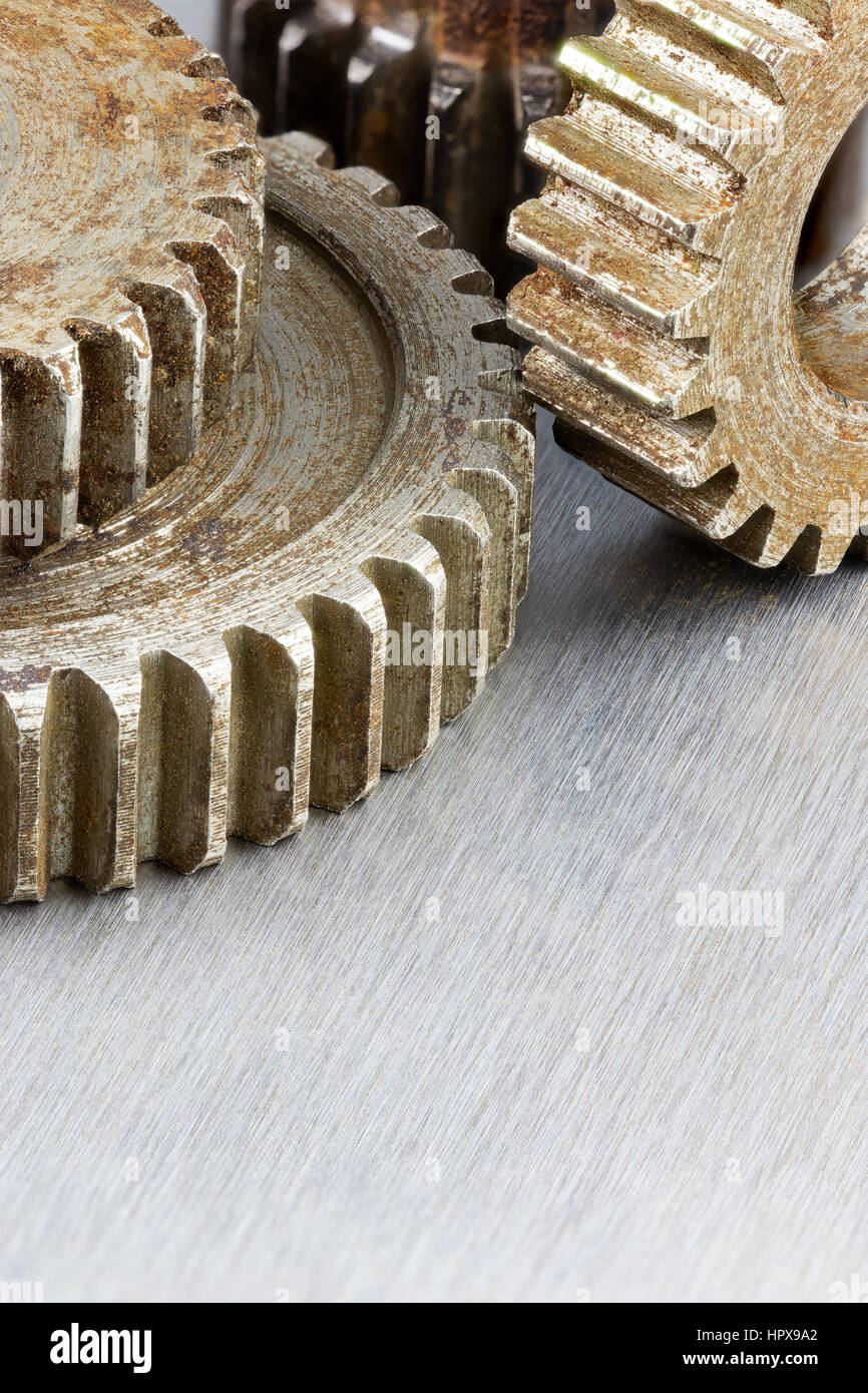 rusty industrial machinery cogwheels on scratched metal background ...