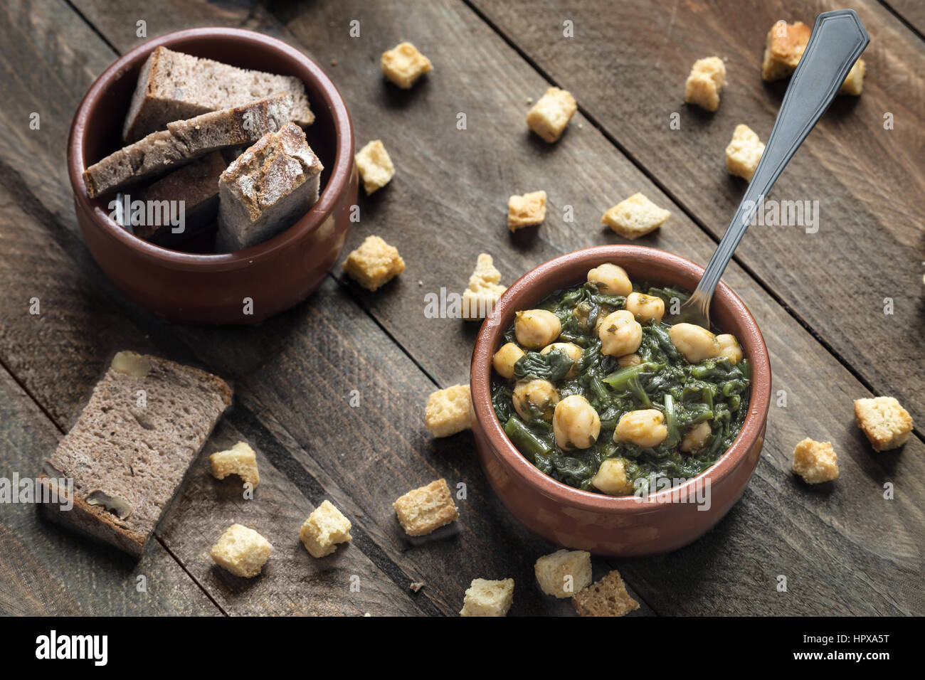 Chickpea stew with spinach on rustic wooden background. Traditional ...