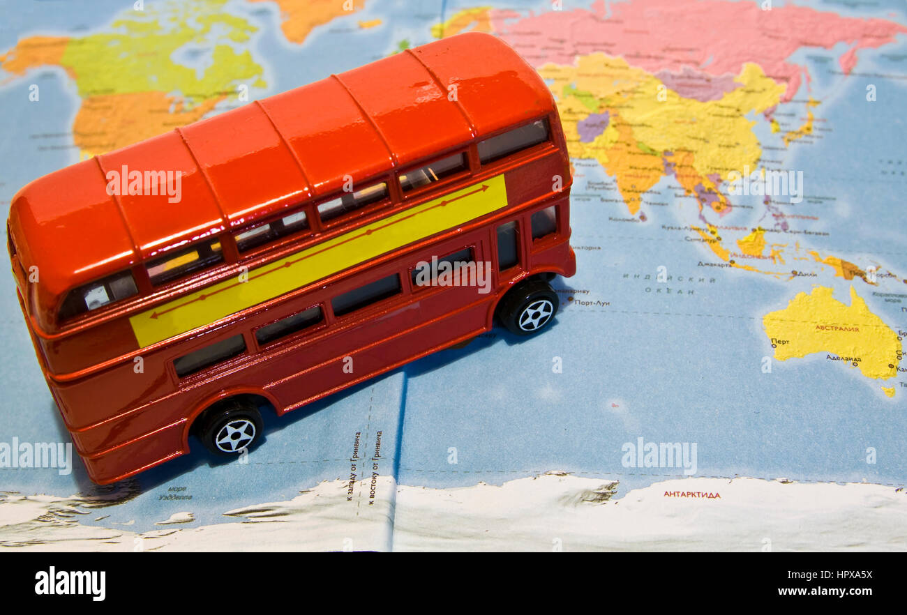 Red toy touristic bus standing on map of the world Stock Photo - Alamy