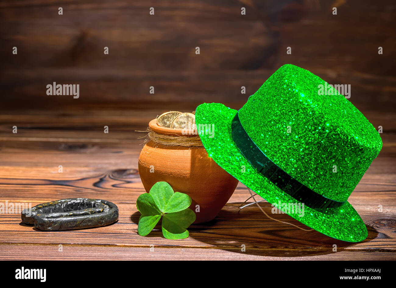 St Patricks day concept with pot full gold coins, horseshoe, green hat ...