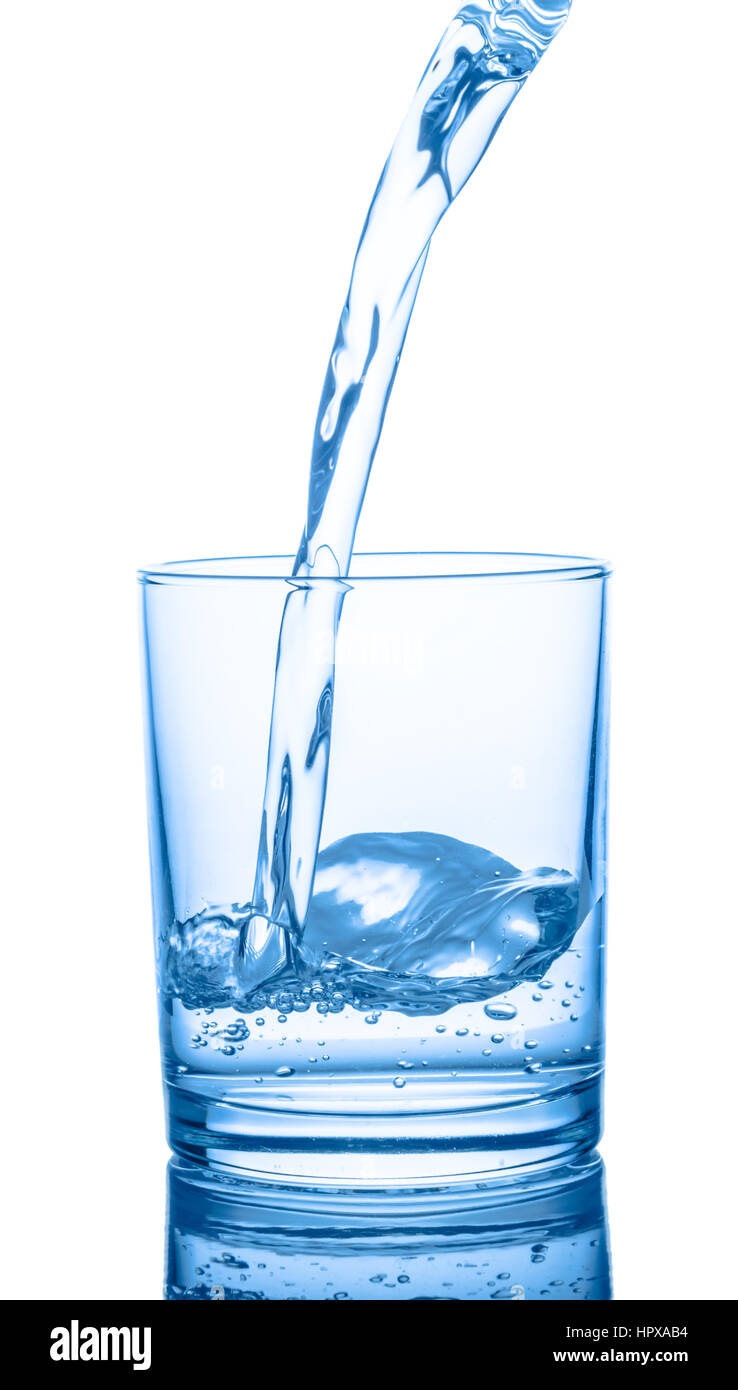 pouring blue water in transparent glass isolated on white background ...