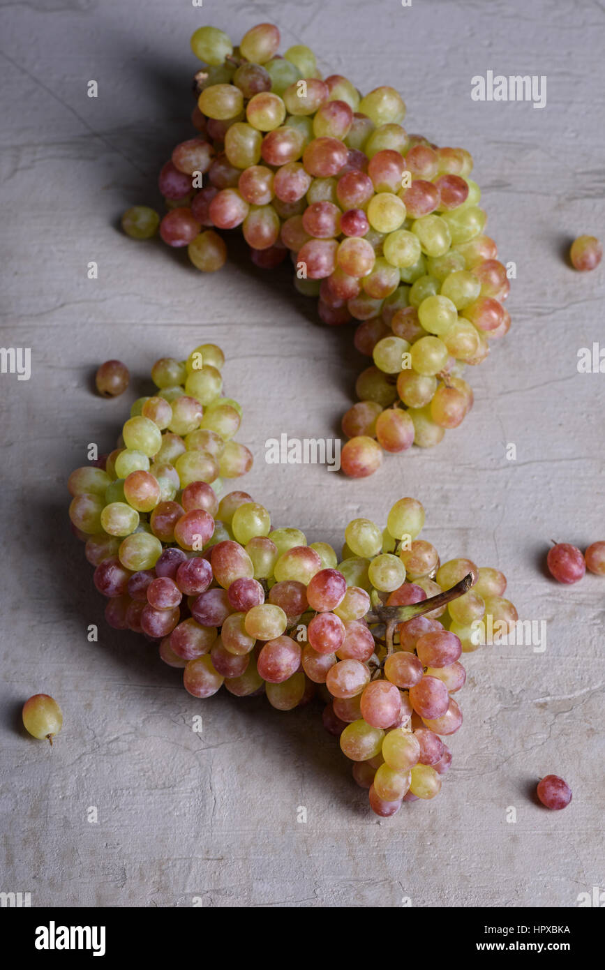 Bunch of grapes over grey background, fresh ripe fruits close up Stock ...