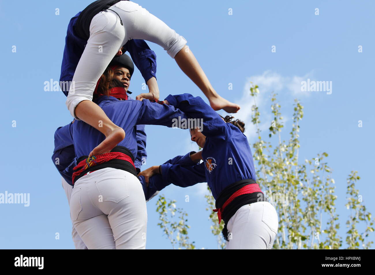 People making human towers, a traditional spectacle in Catalonia called ...