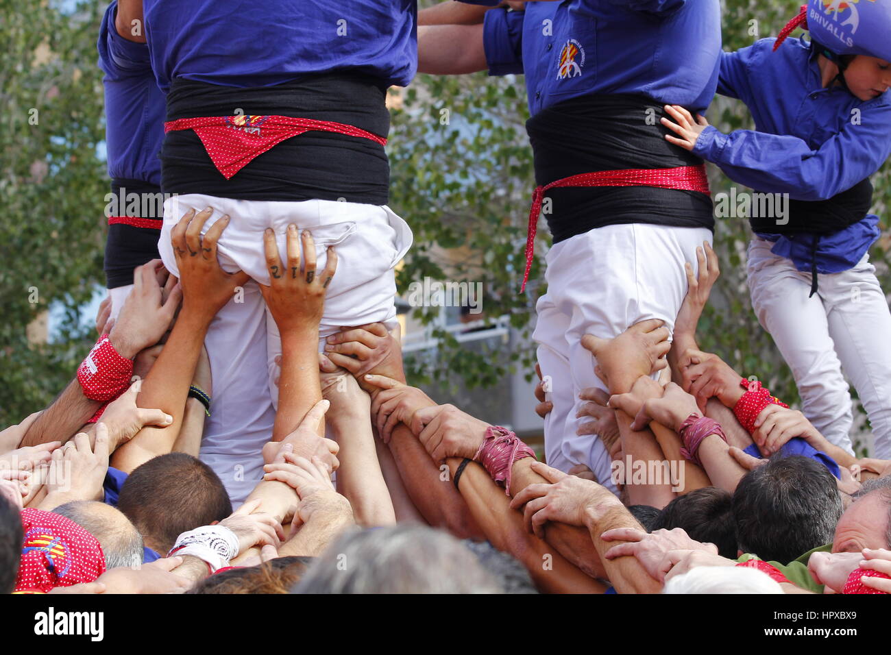 People making human towers, a traditional spectacle in Catalonia called ...