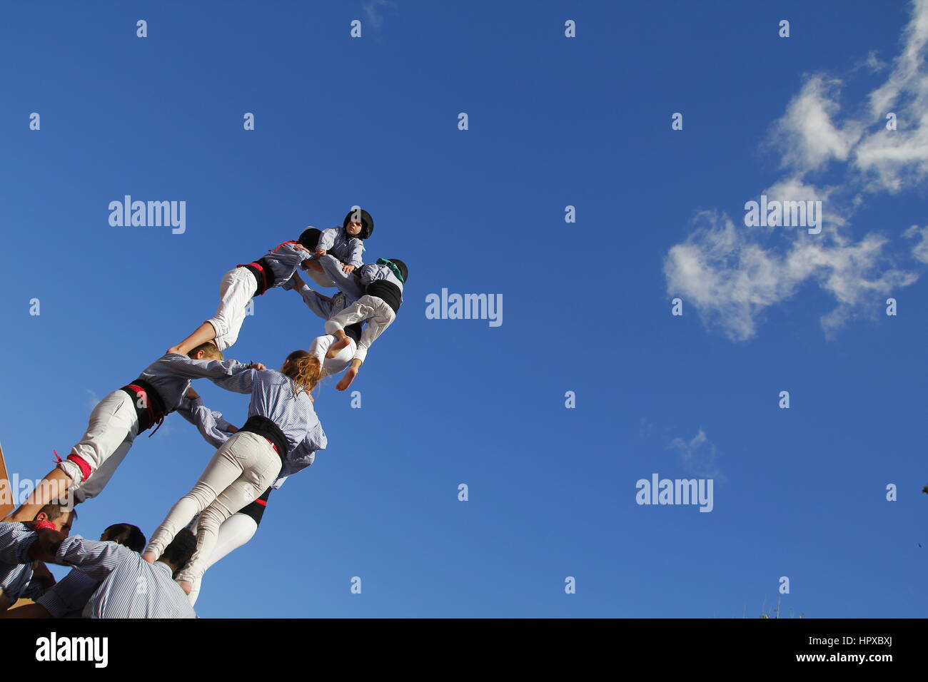 People making human towers, a traditional spectacle in Catalonia called ...