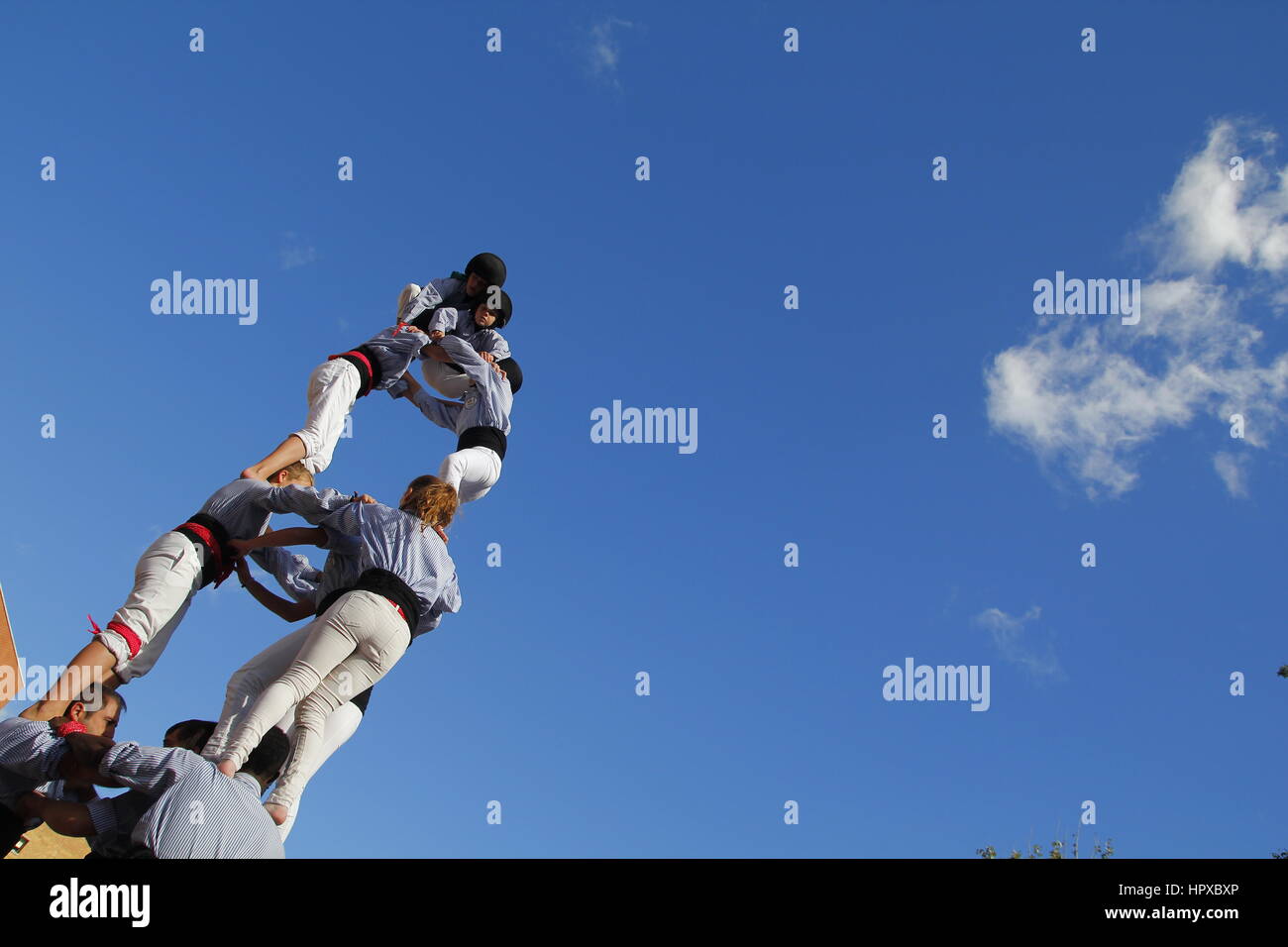 People making human towers, a traditional spectacle in Catalonia called ...