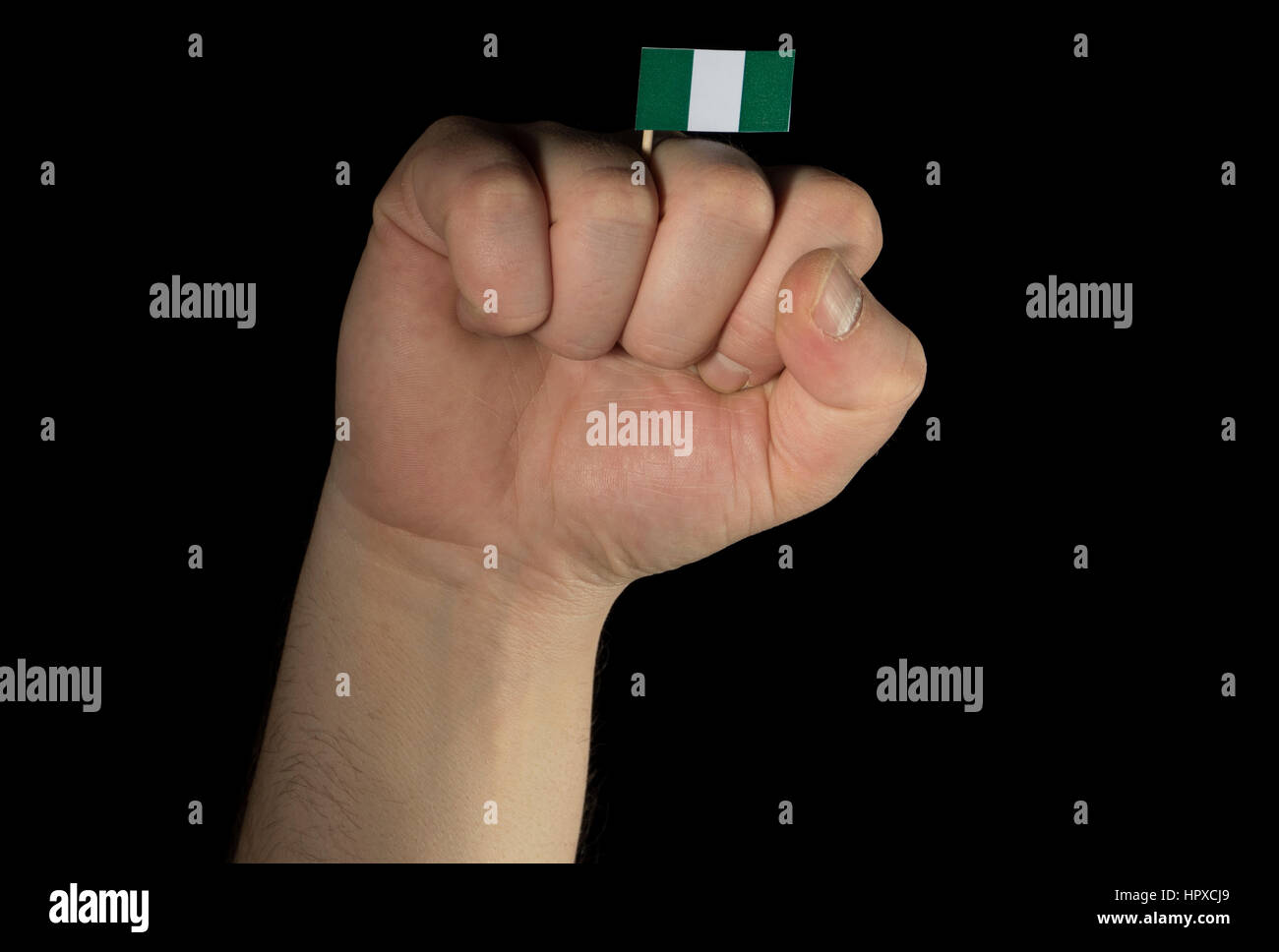 Man hand fist with Nigerian flag isolated on black background Stock ...