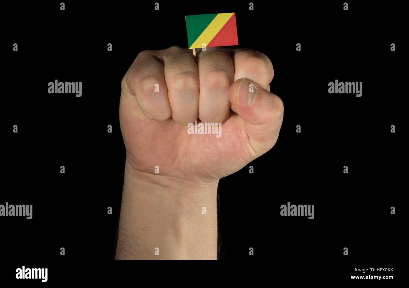 Man hand fist with Republic of Congo flag isolated on black background ...