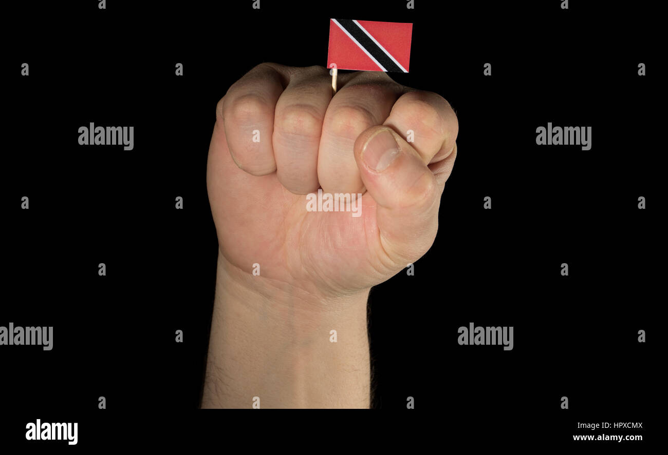 Man hand fist with Trinidad and Tobago flag isolated on black ...