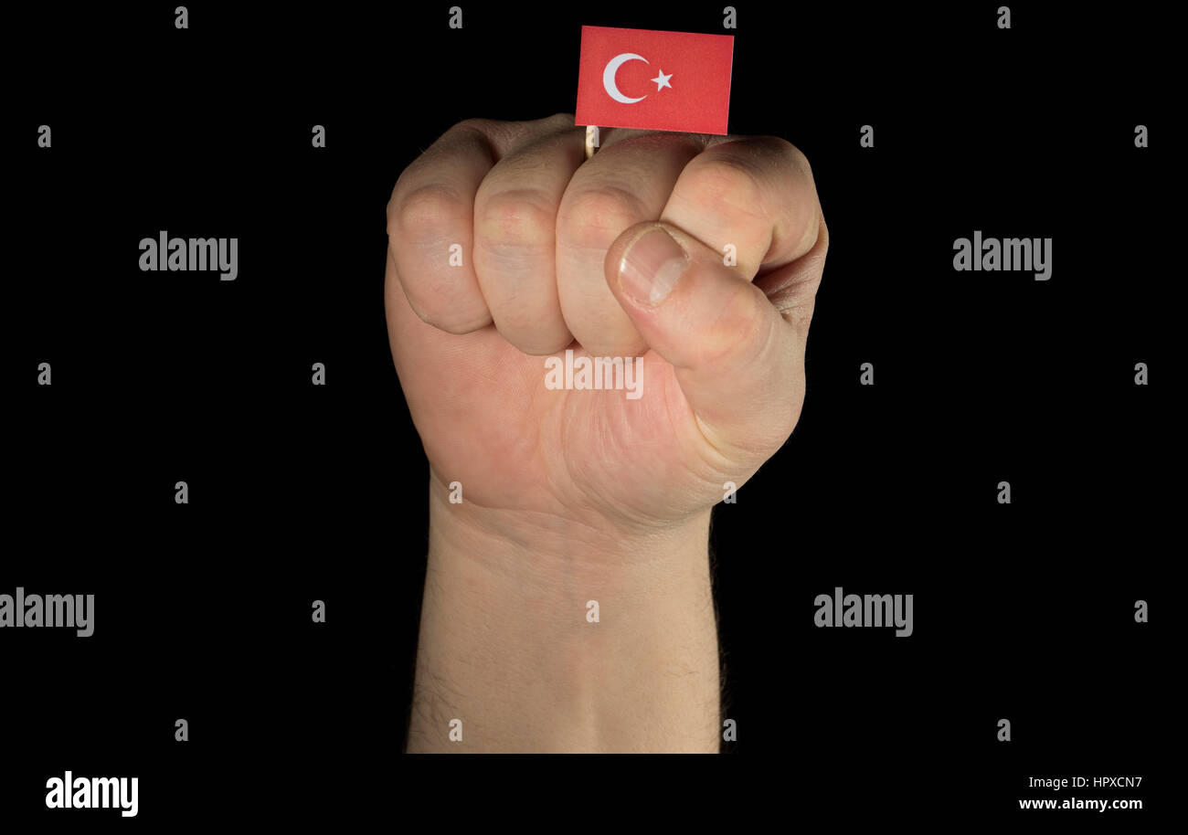 Man hand fist with Turkish flag isolated on black background Stock ...