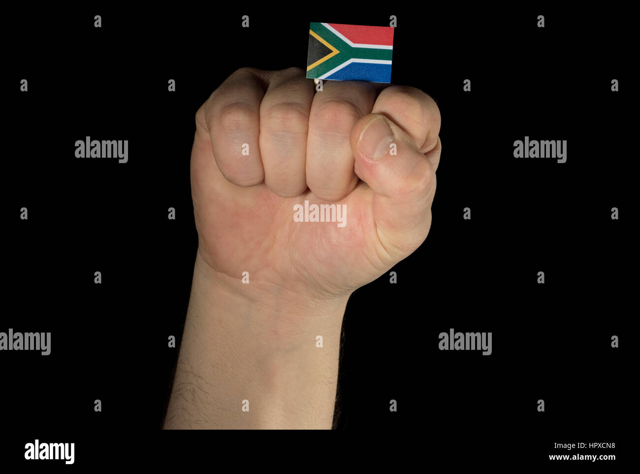 Man hand fist with South African flag isolated on black background ...