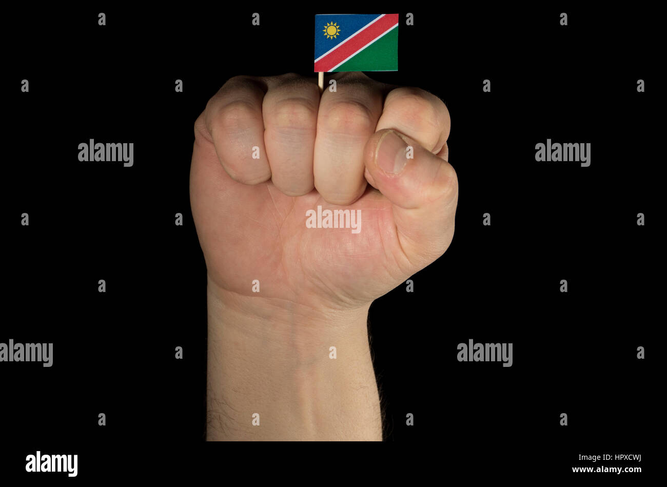 Man hand fist with Namibian flag isolated on black background Stock ...