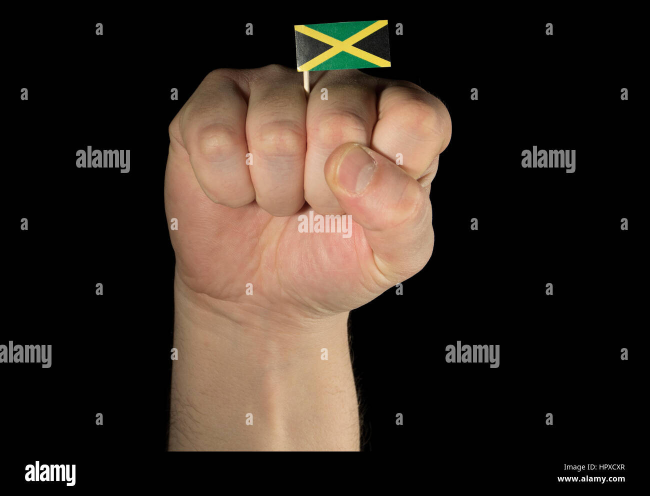 Man hand fist with Jamaican flag isolated on black background Stock ...