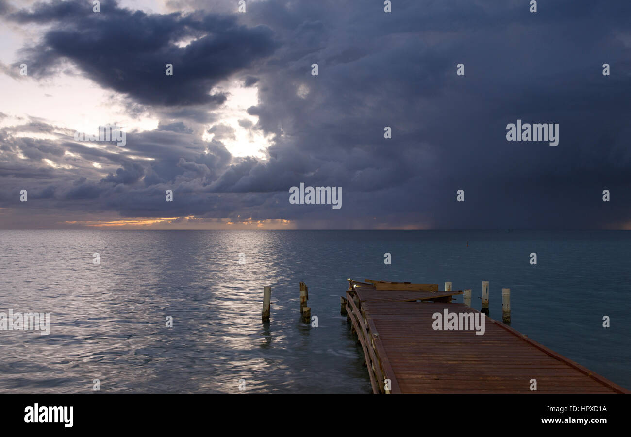 Dock, storm clouds, Playa Combate, Puerto Rico Stock Photo - Alamy
