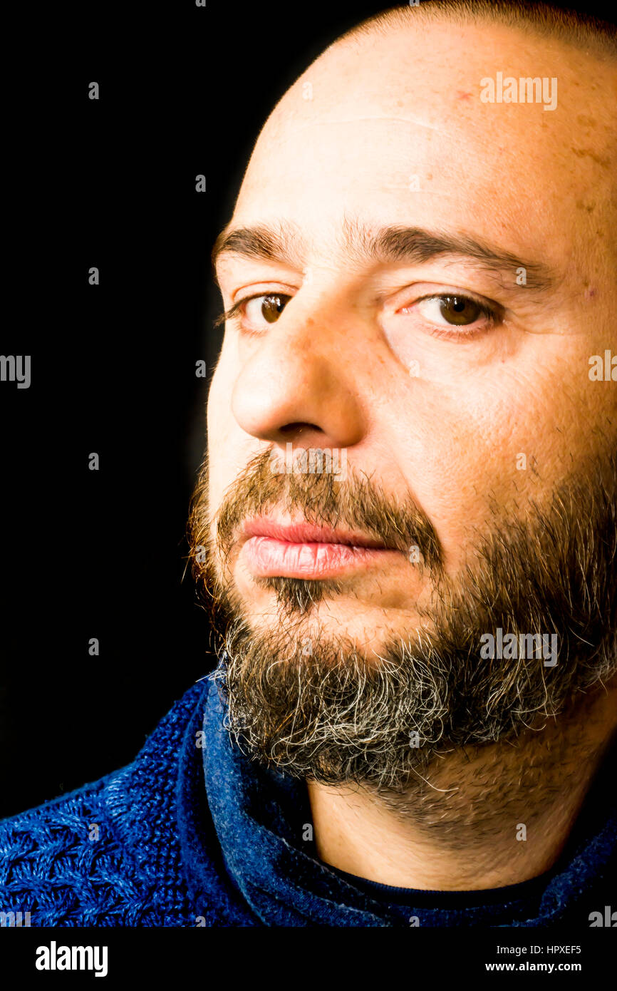 Handsome, bald man with beard on black background Stock Photo - Alamy
