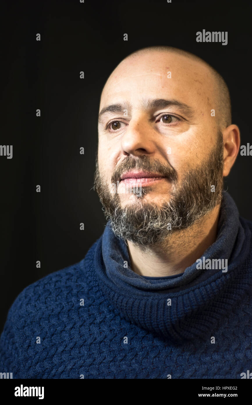Handsome, bald man with beard on black background Stock Photo - Alamy