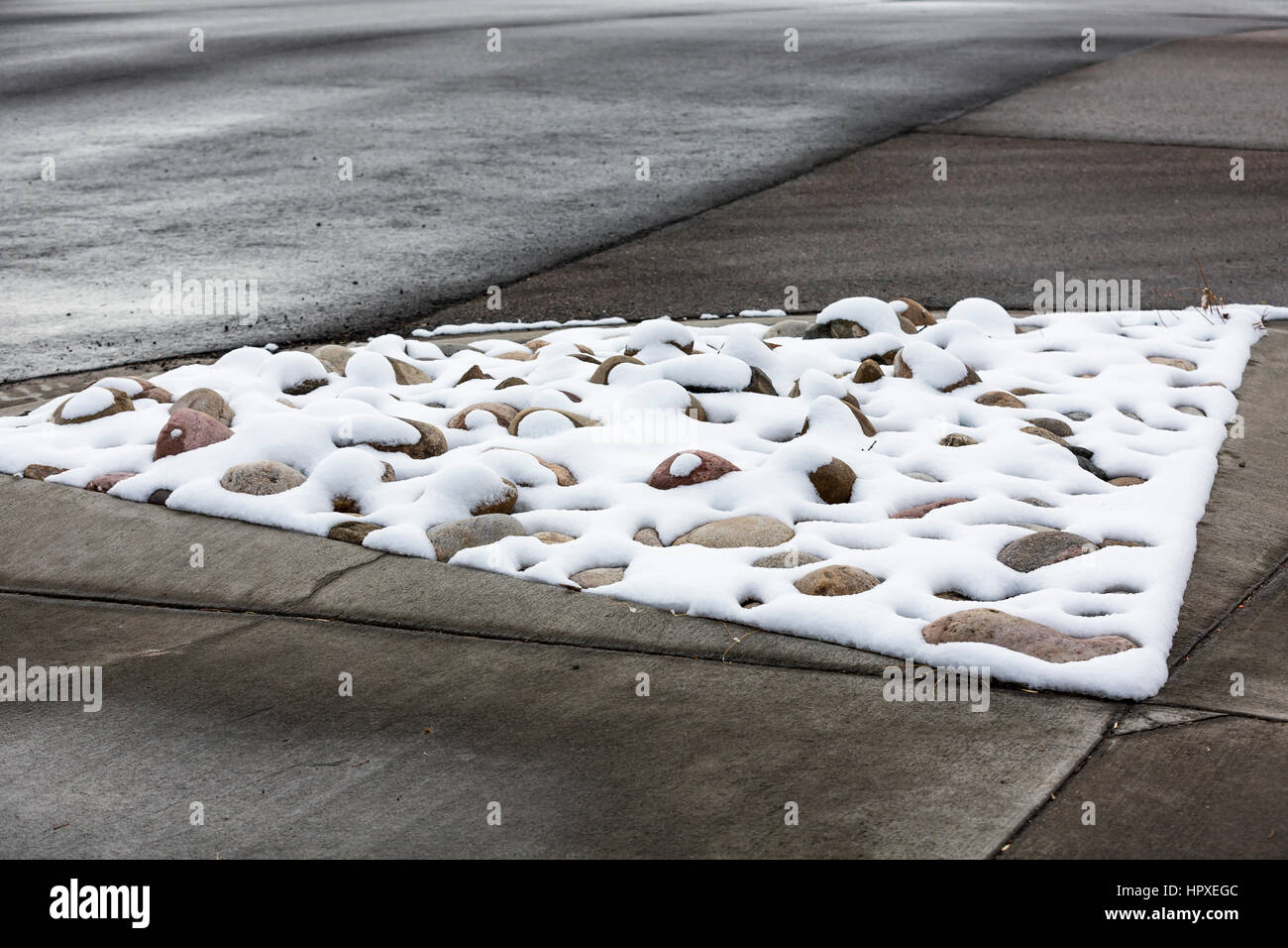 Snow on a sidewalk Stock Photo - Alamy