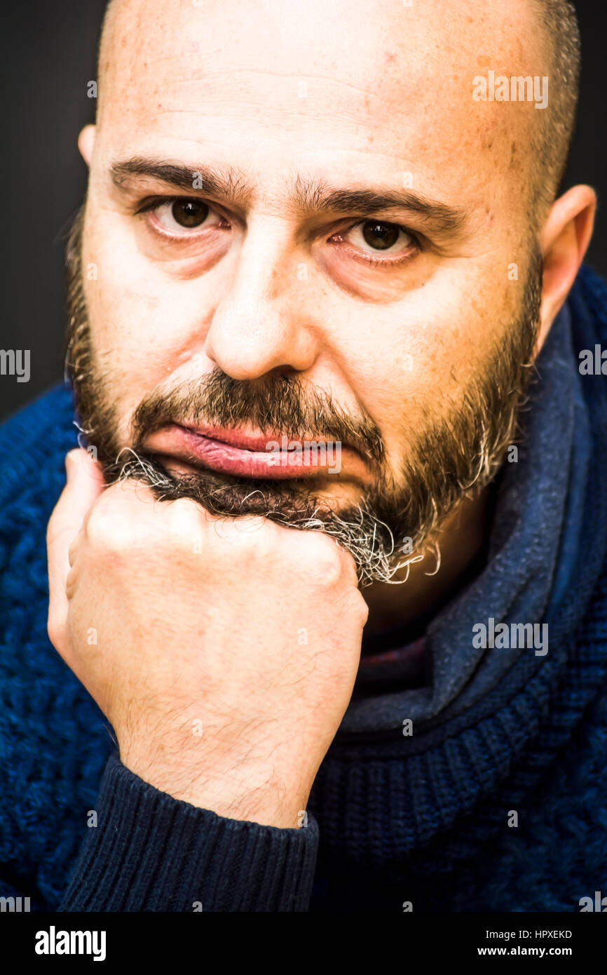 Handsome, bald man with beard on black background Stock Photo - Alamy
