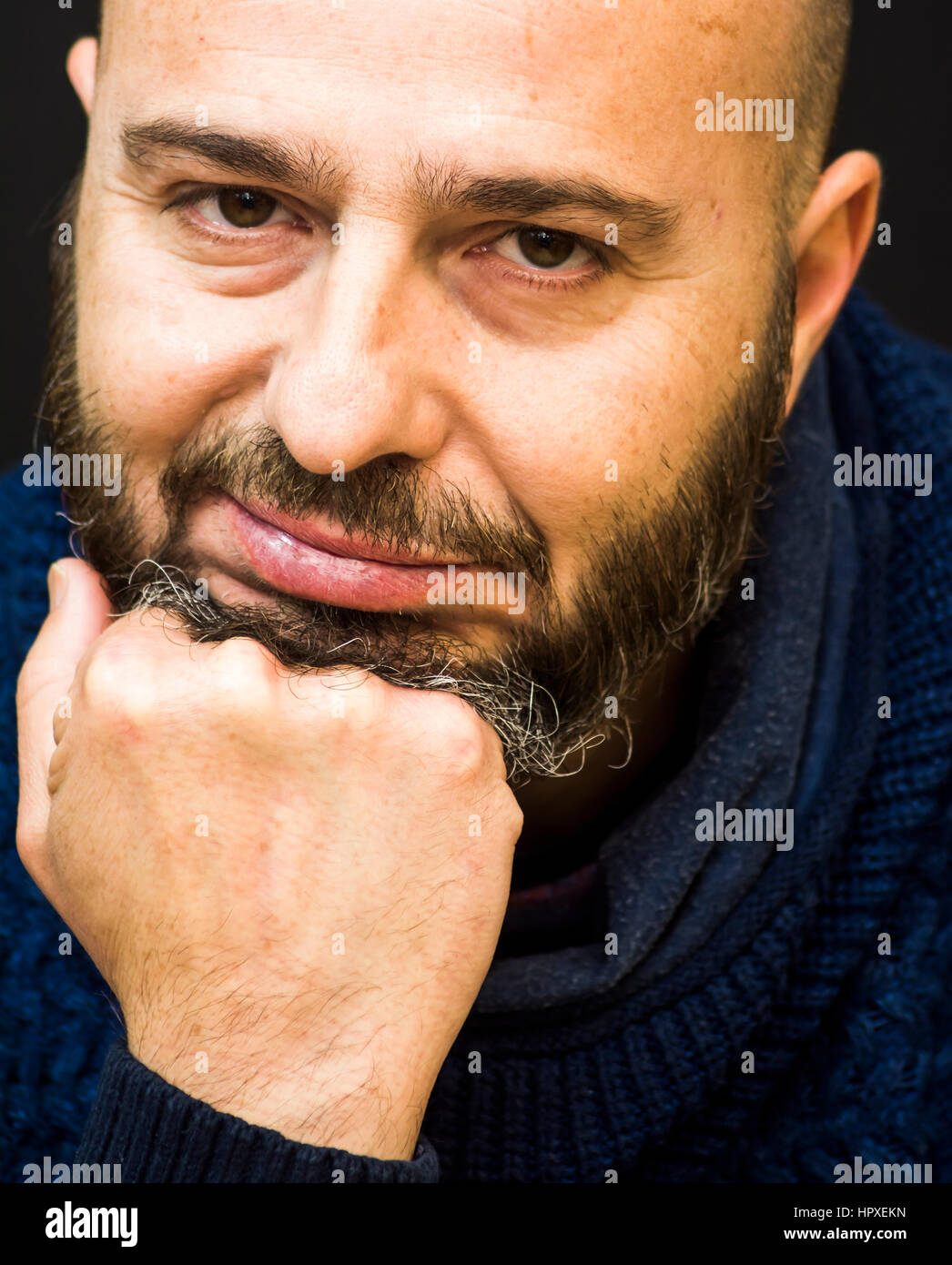 Handsome, bald man with beard on black background Stock Photo - Alamy