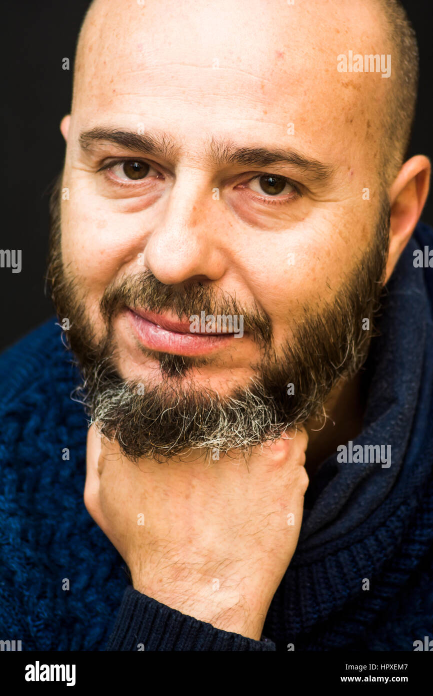 Handsome, bald man with beard on black background Stock Photo - Alamy