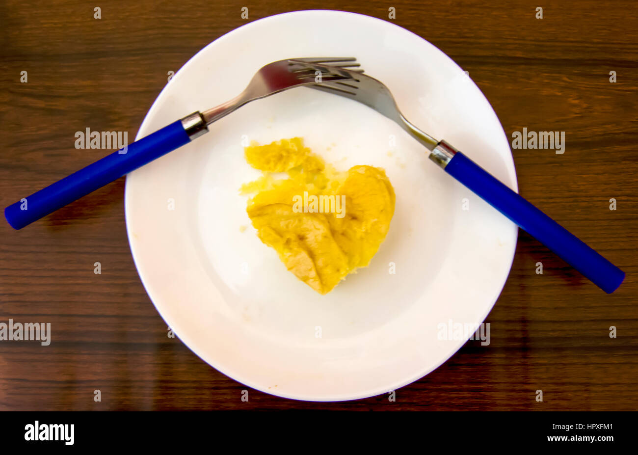 Piece of apple pie with heart shape and two forks interlaced on a ...
