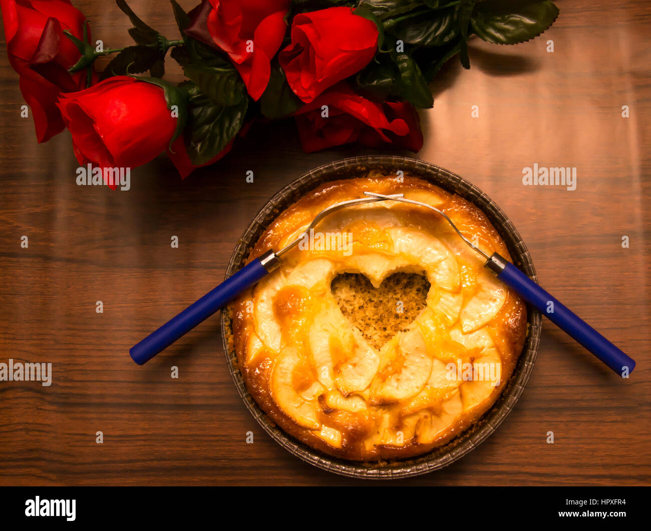 Apple pie with a hollow in the shape of a heart and two forks ...