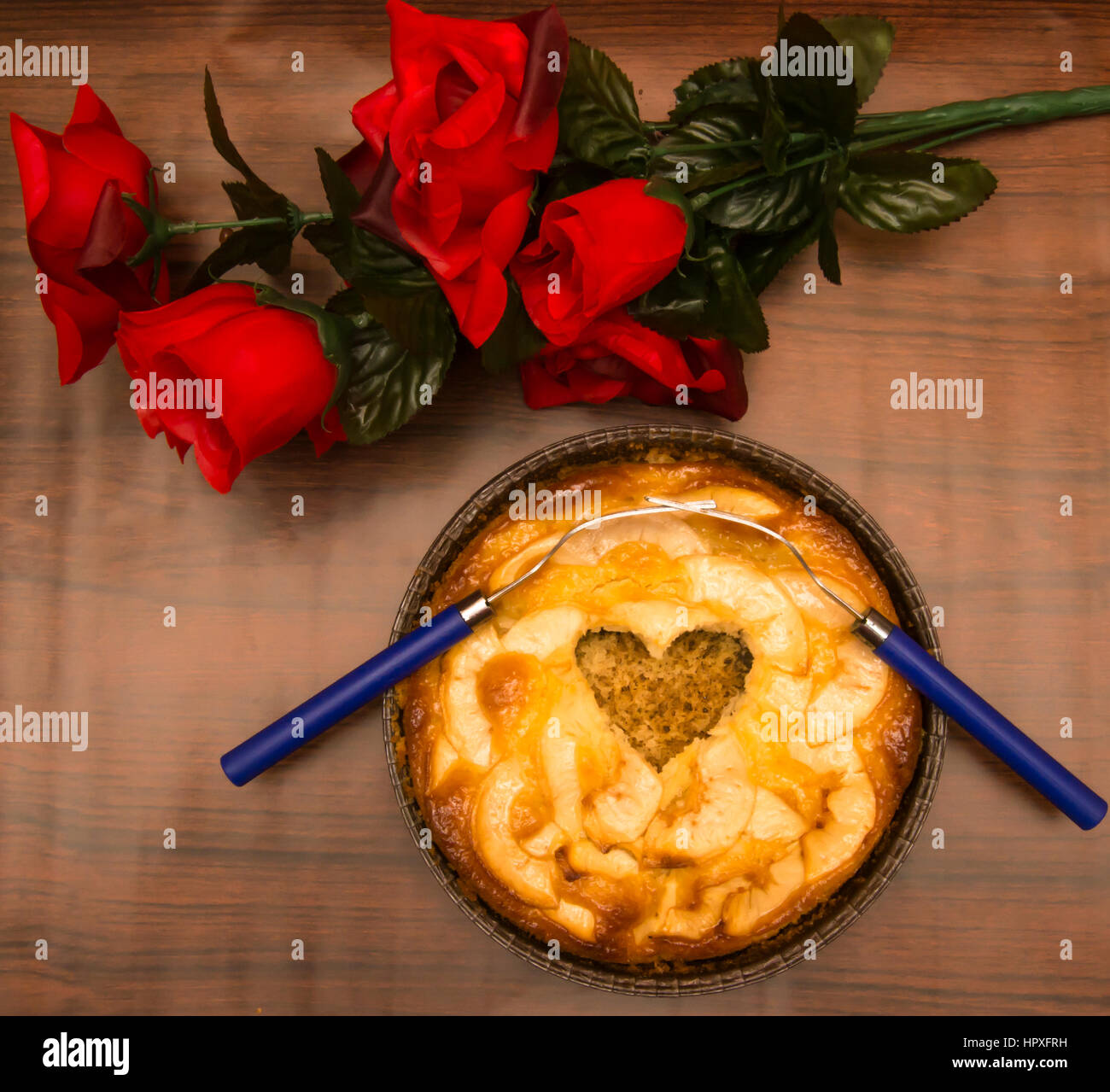 Apple pie with a hollow in the shape of a heart and two forks ...