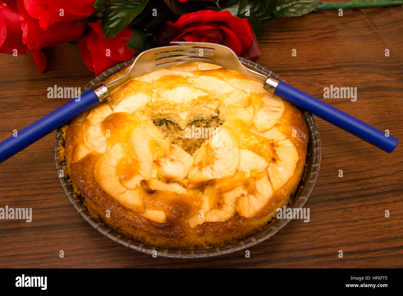 Apple pie with a hollow in the shape of a heart and two forks ...