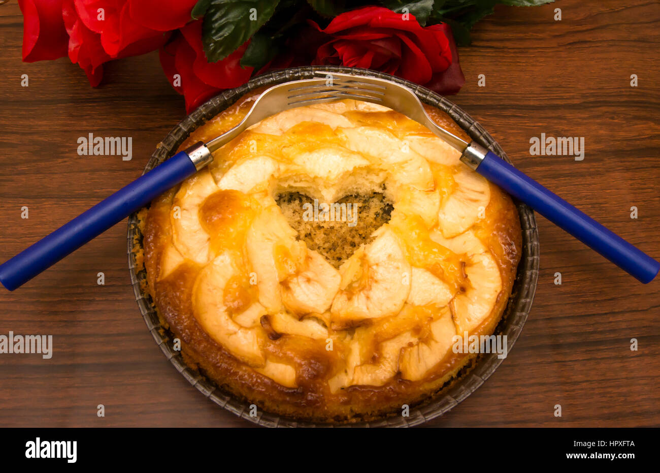 Apple pie with a hollow in the shape of a heart and two forks ...